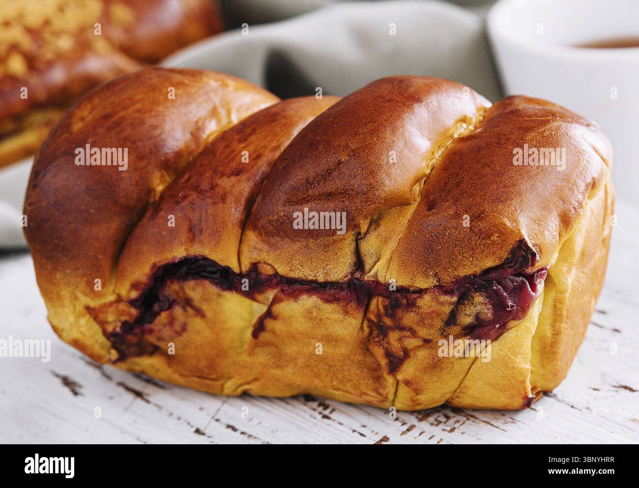 food still-life, Delicious baked bun with cherry on white wood Stock ...