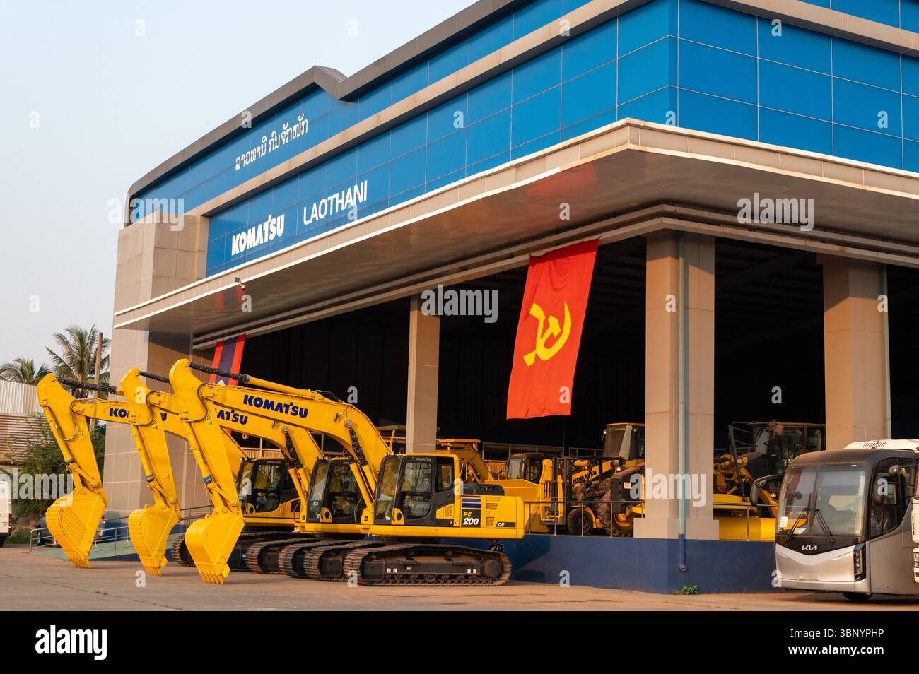 A large dealership with a suspending Hammer and Sickle red flag. The ...