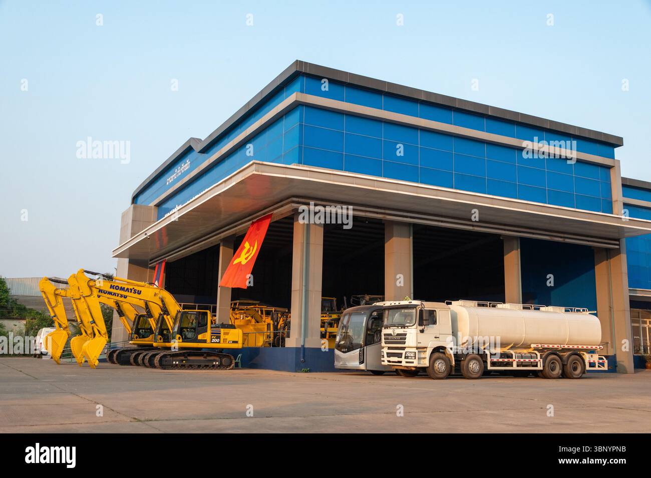 A large dealership with a suspending Hammer and Sickle red flag. The ...