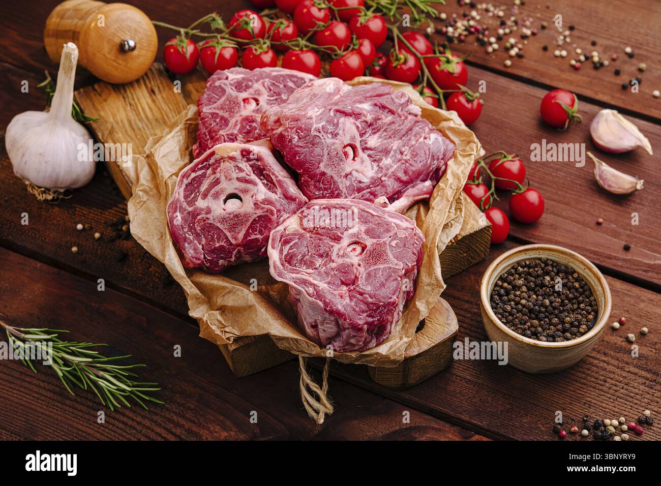 food still-life, A selection of fresh meat cuts is displayed on a ...
