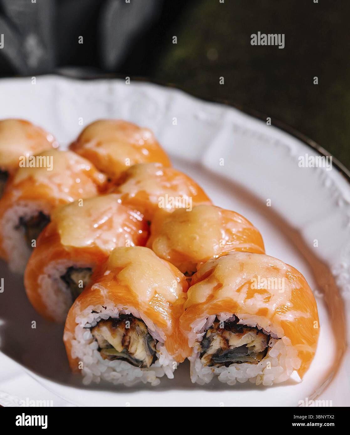 Salmon Fried sushi roll with eel and cheese Stock Photo - Alamy