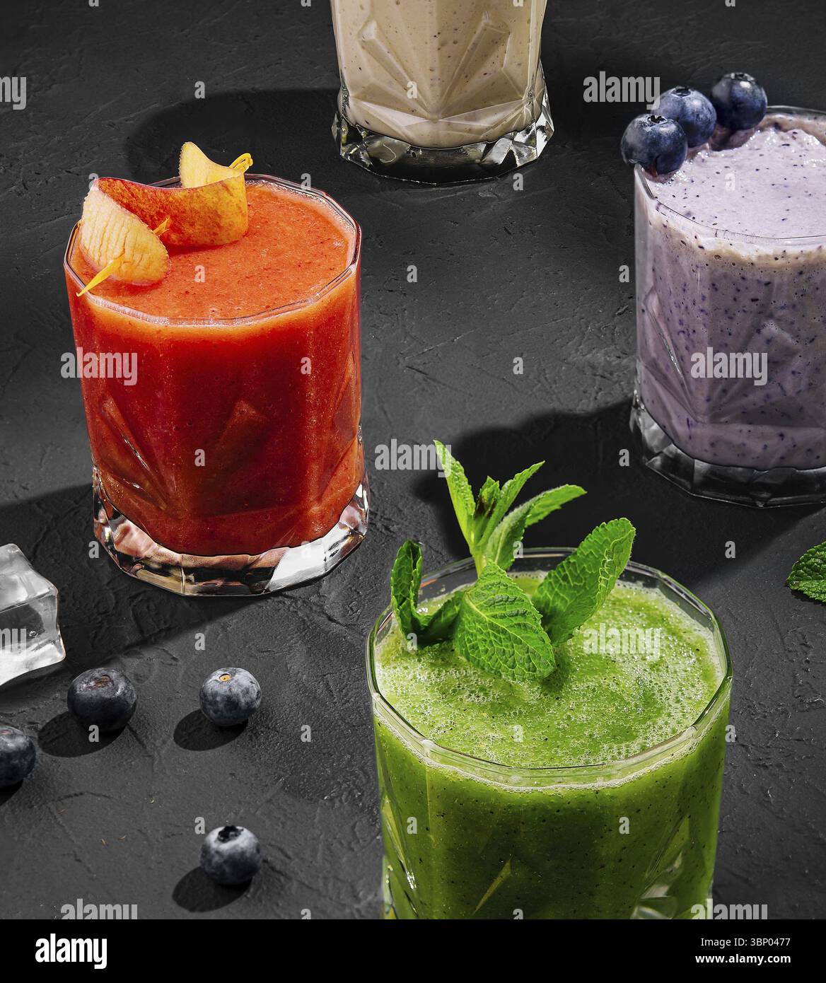 Freshly blended fruit smoothies of various colors and tastes in glass ...