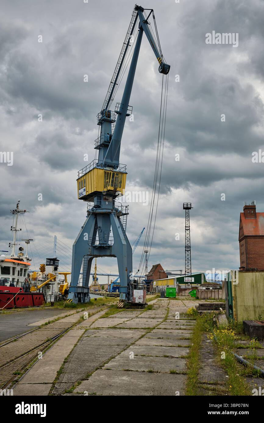 June 30, 2025 – Stralsund, Germany: Faded red workboat and old gray ...