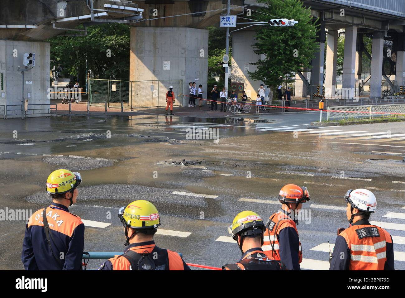 A road is flooded after a water pipe burst in Higashiyodogawa Ward ...