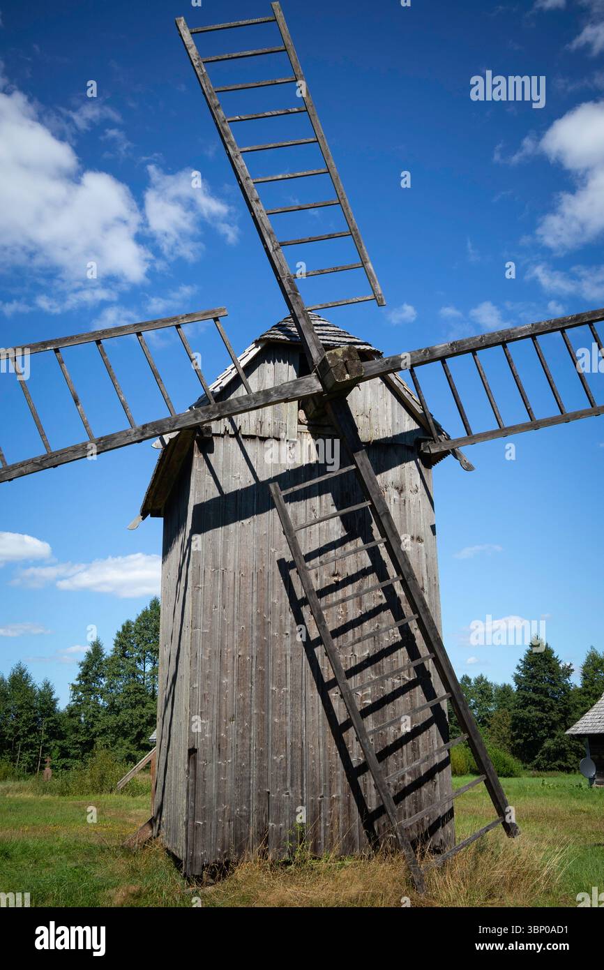 A windmill with wooden steps leading up to it. The windmill is old and ...