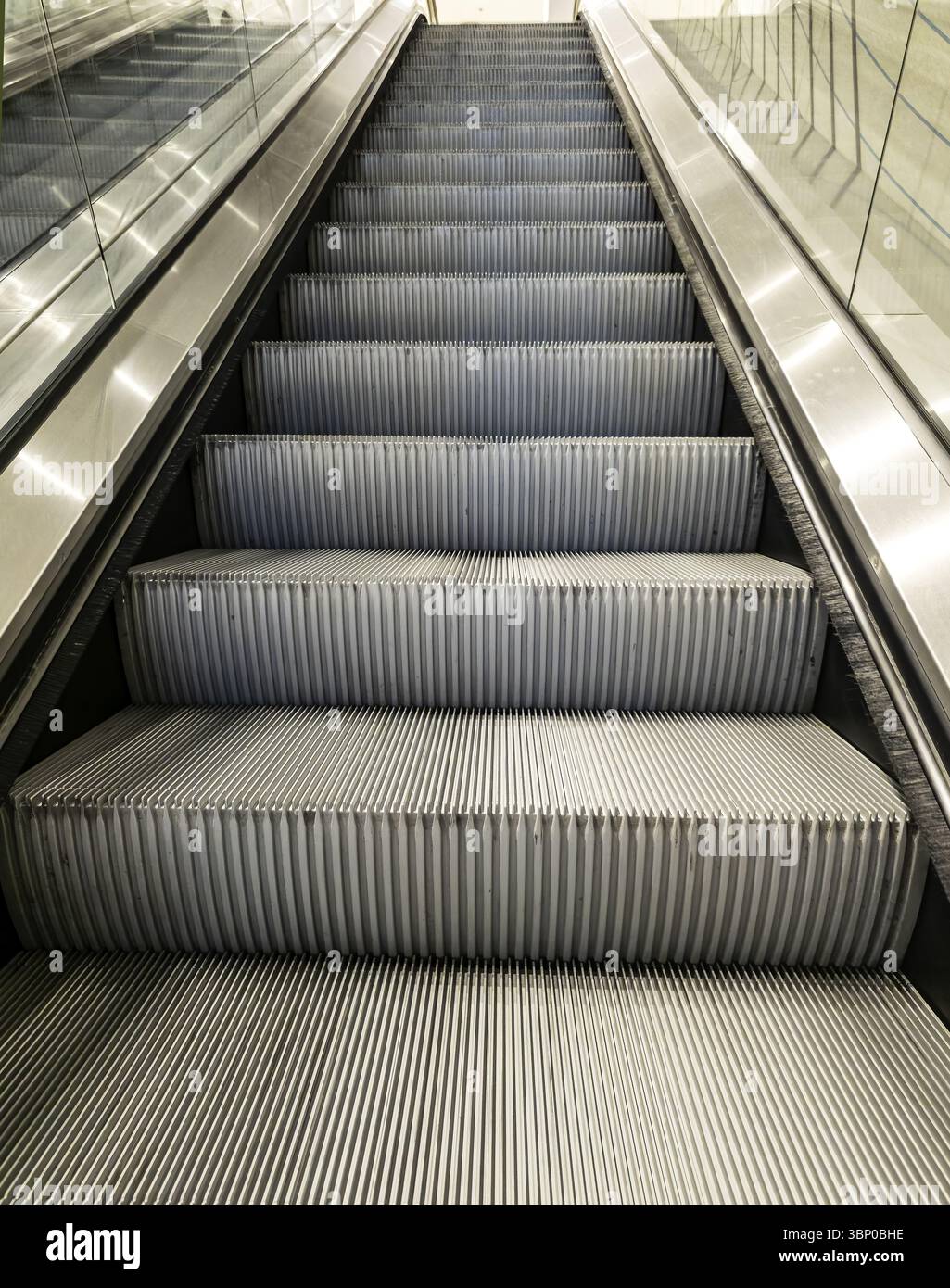 Metal escalators inside a supermarket, transportation and accessibility ...