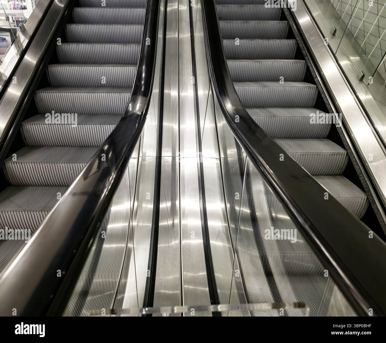 Metal escalators inside a supermarket, transportation and accessibility ...