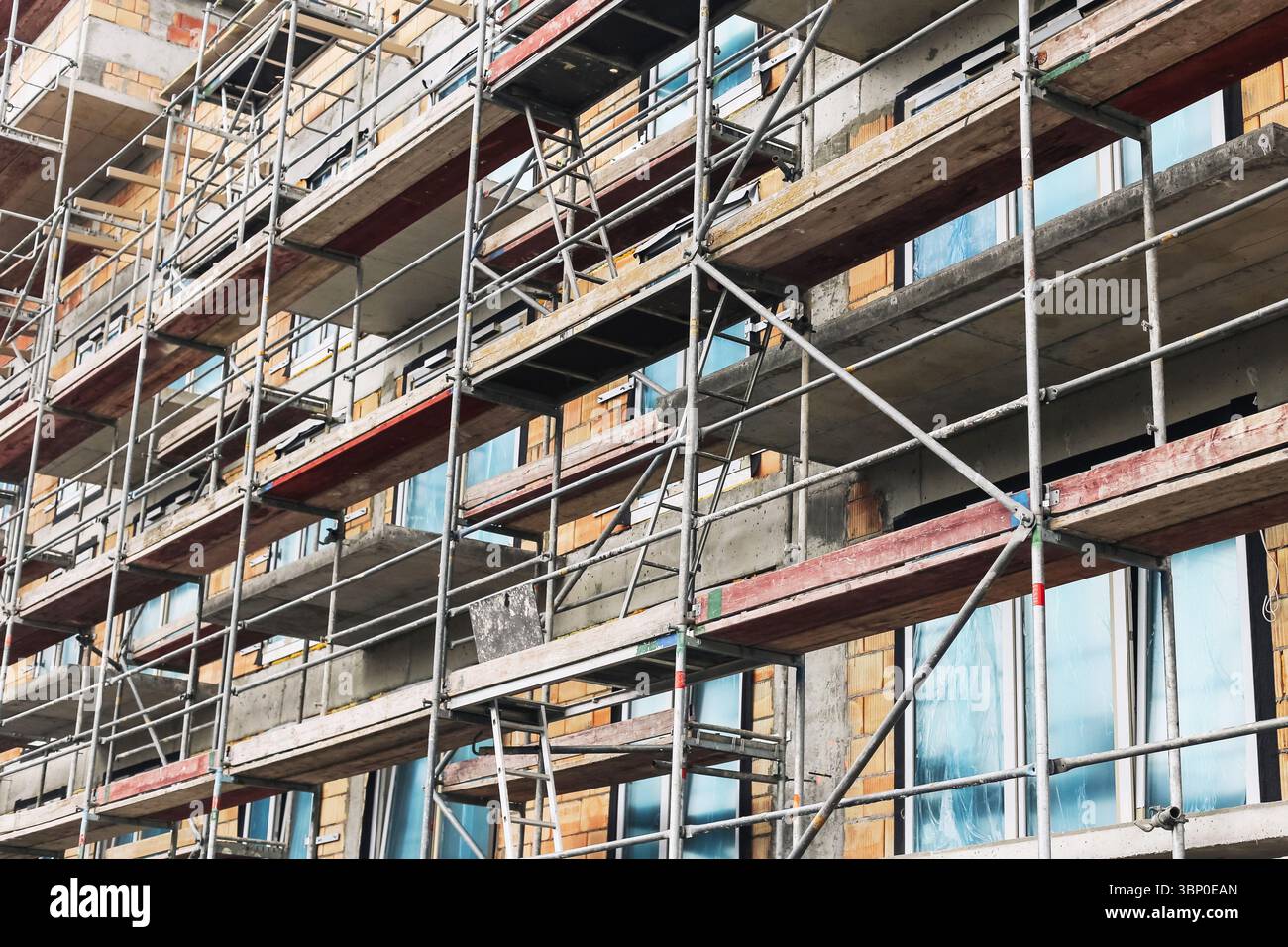 Construction scaffolding on tall building. Industrial renovation with ...