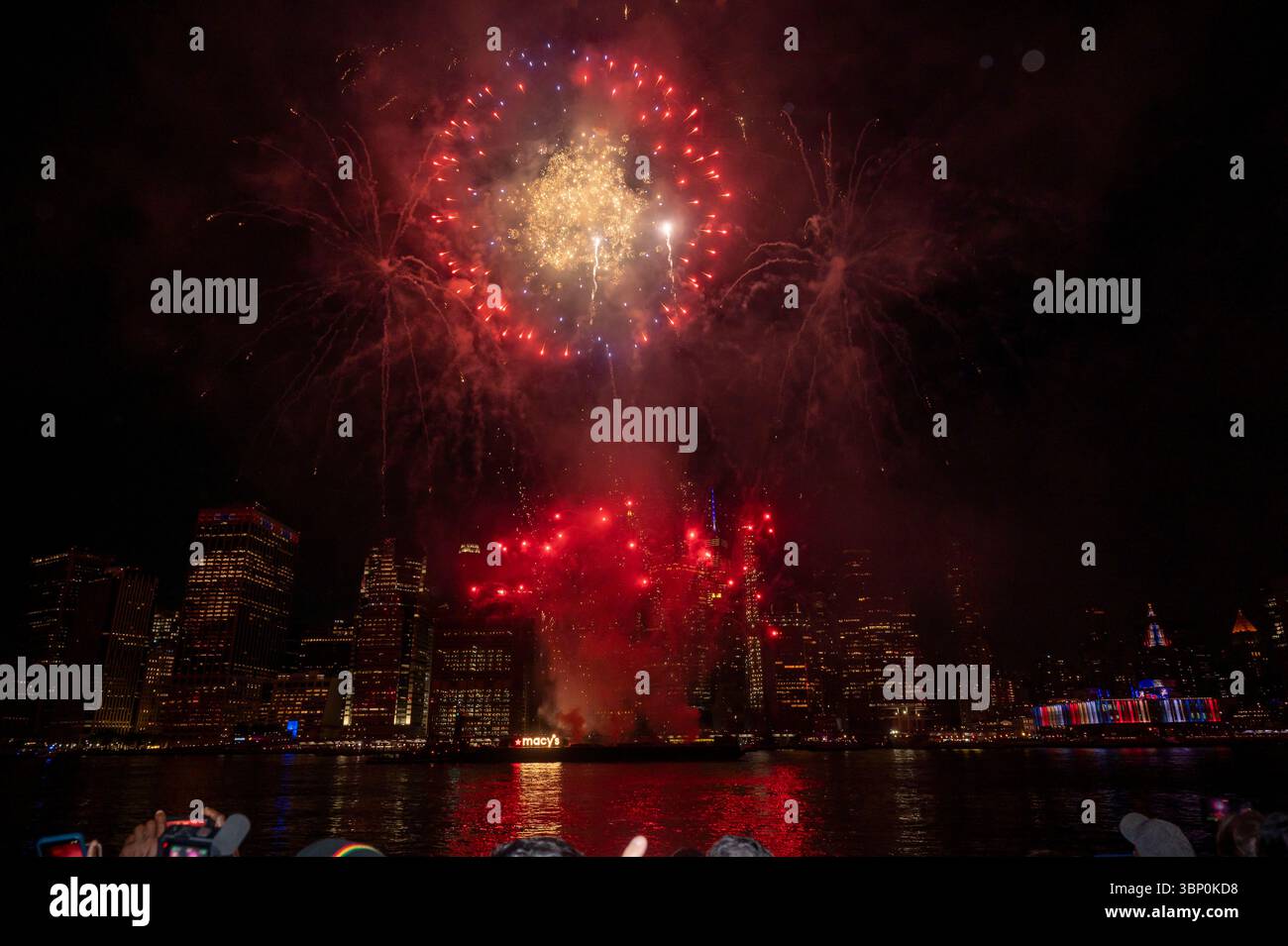 Spectators view and take photos of fireworks explode over the Brooklyn ...