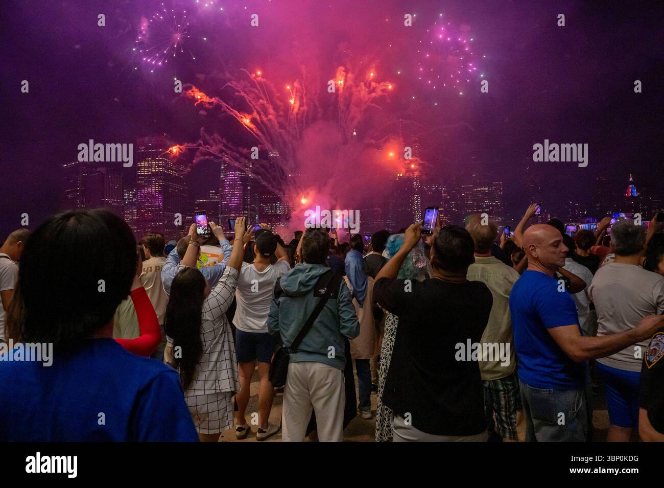 Spectators view and take photos of fireworks explode over the Brooklyn ...
