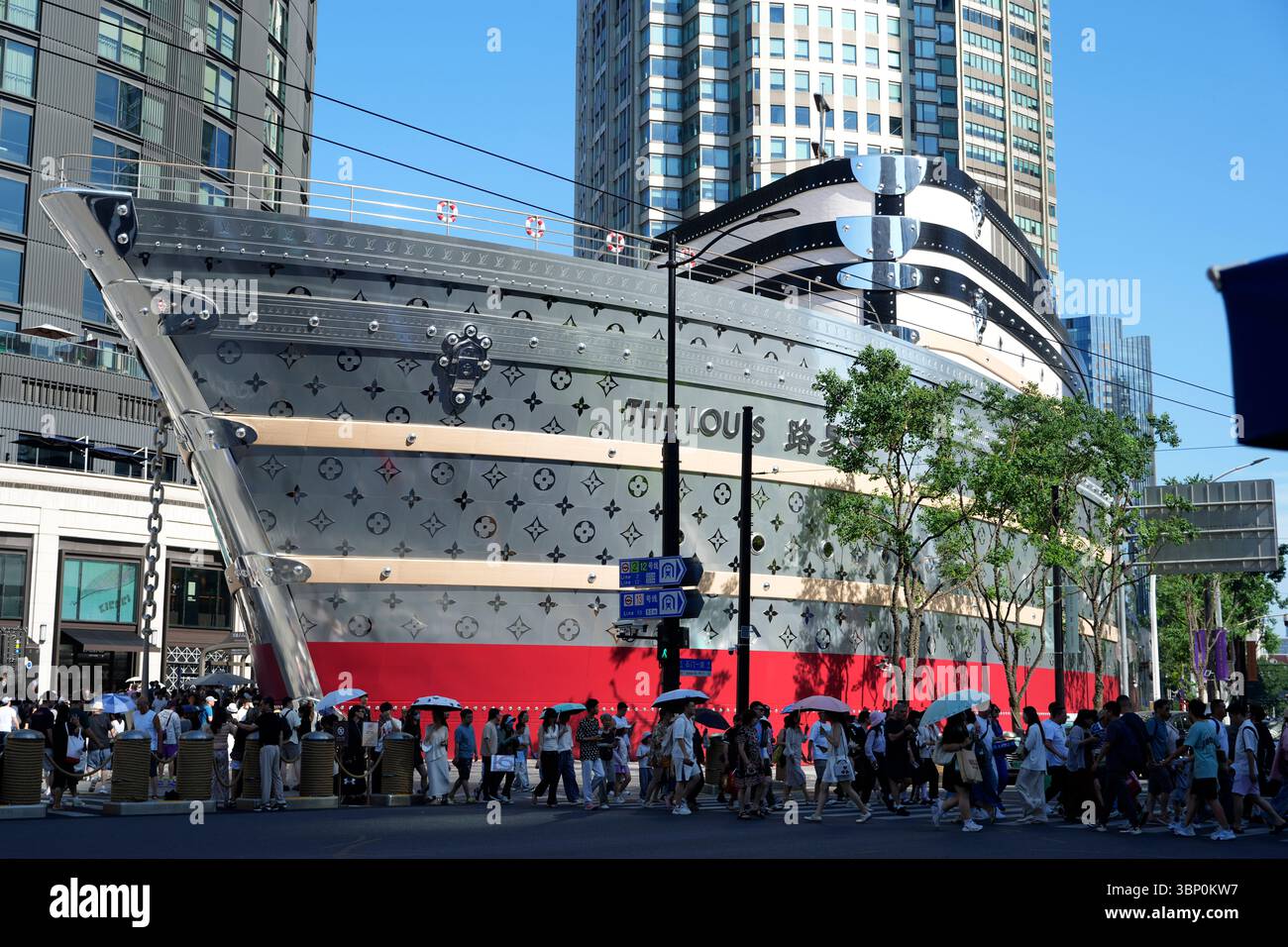 Visitors past Louis Vuitton's ship-shaped store 'The Louis' in Shanghai ...