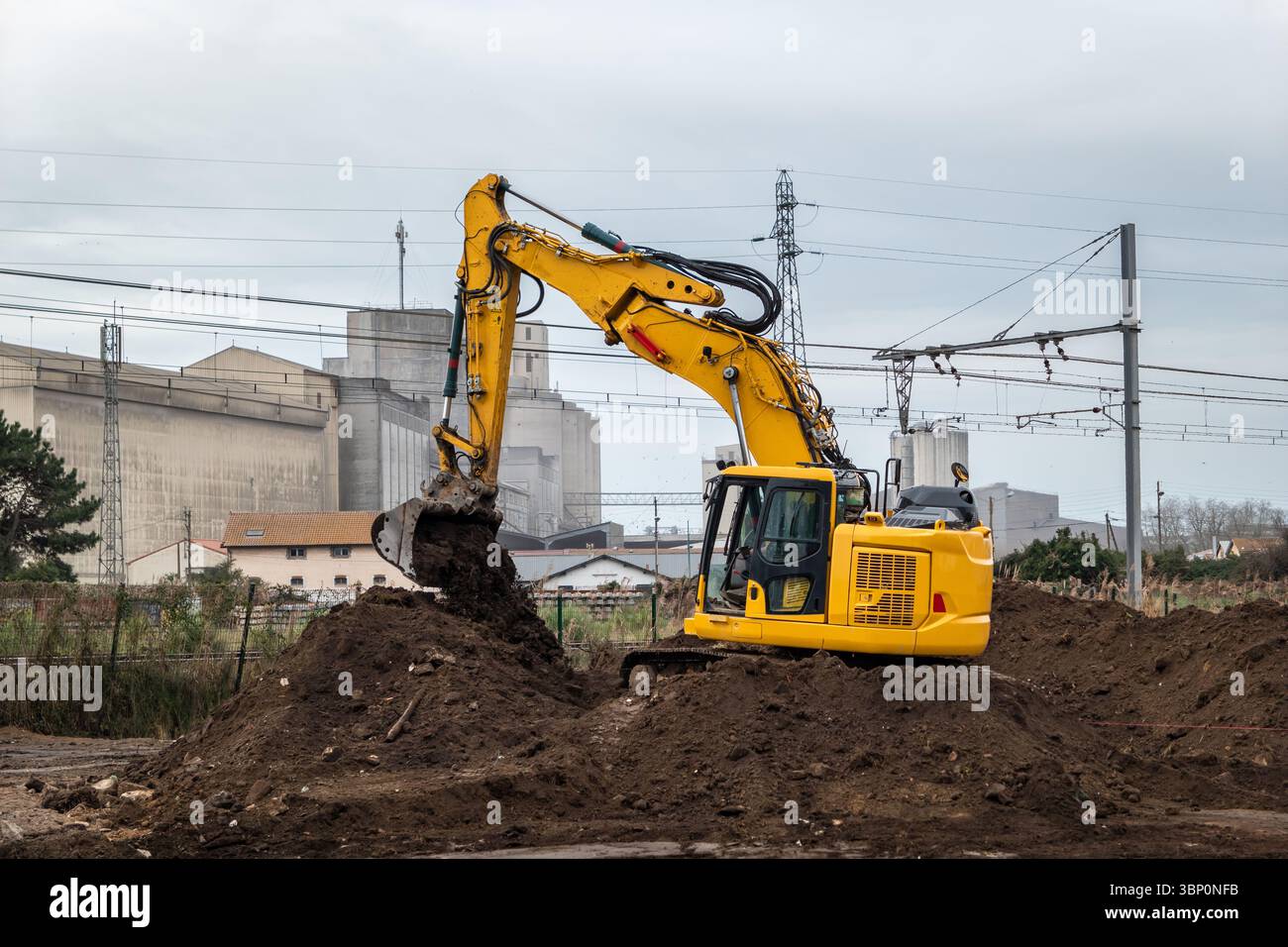 Preparing the site for residential construction with a rotary backhoe ...