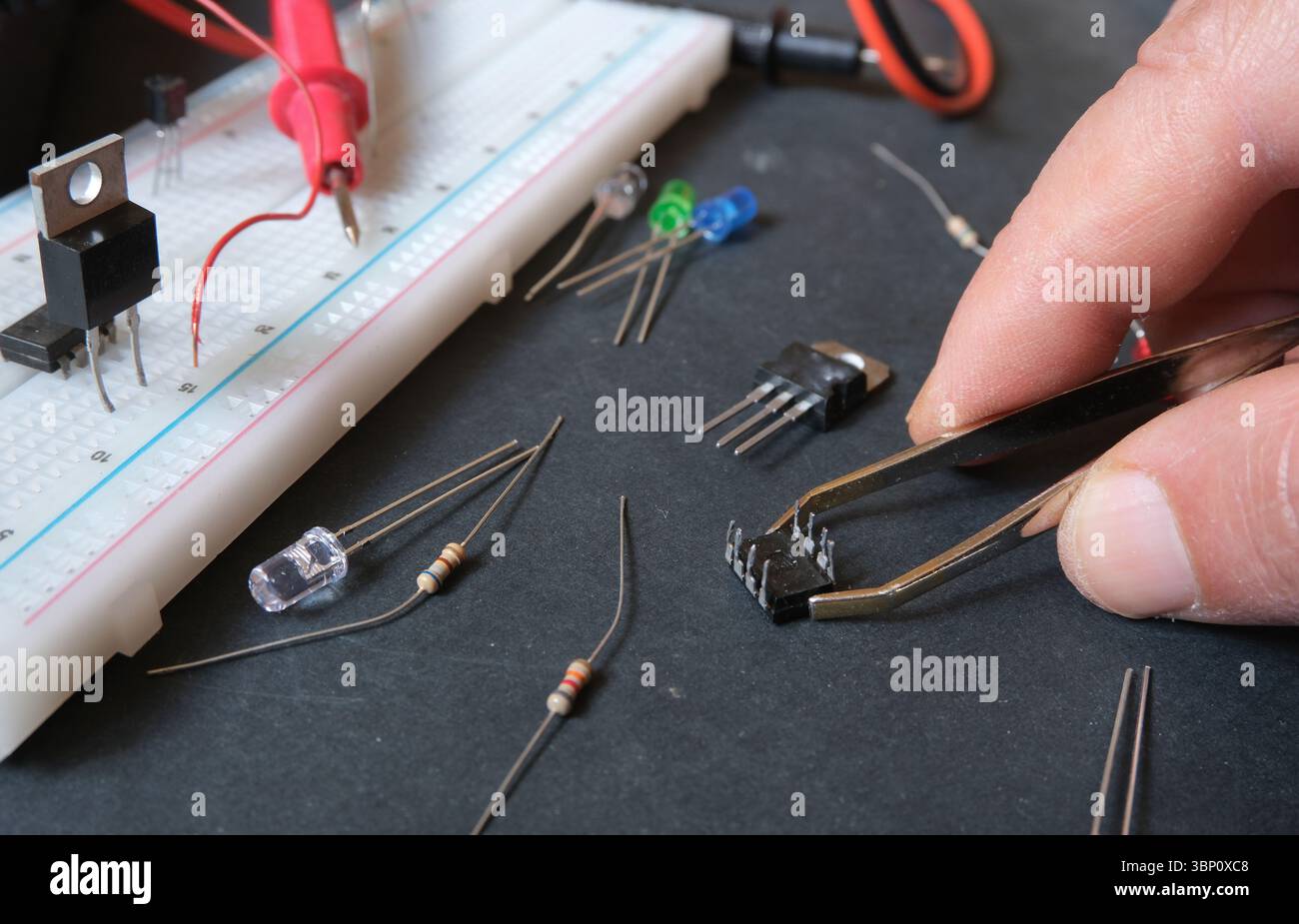 Electronics construction in laboratory. Hands connecting wires to ...