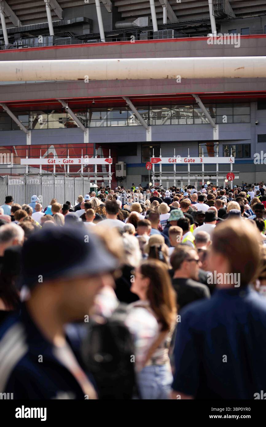 Fans queue for the Oasis reunion concert on Friday, July 4, 2025, in ...