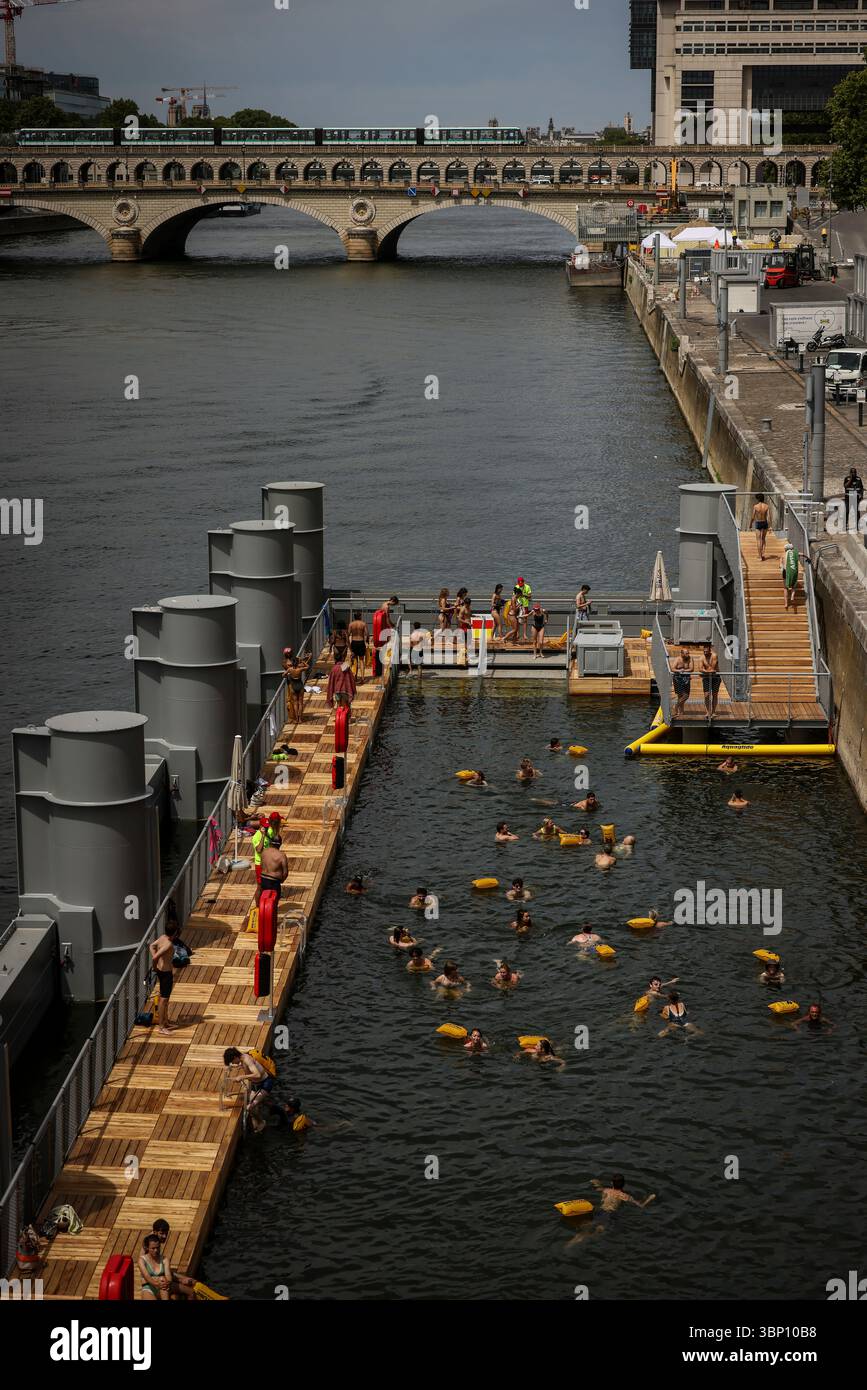 People swim at the Bercy safe bathing site on the Seine river in Paris ...