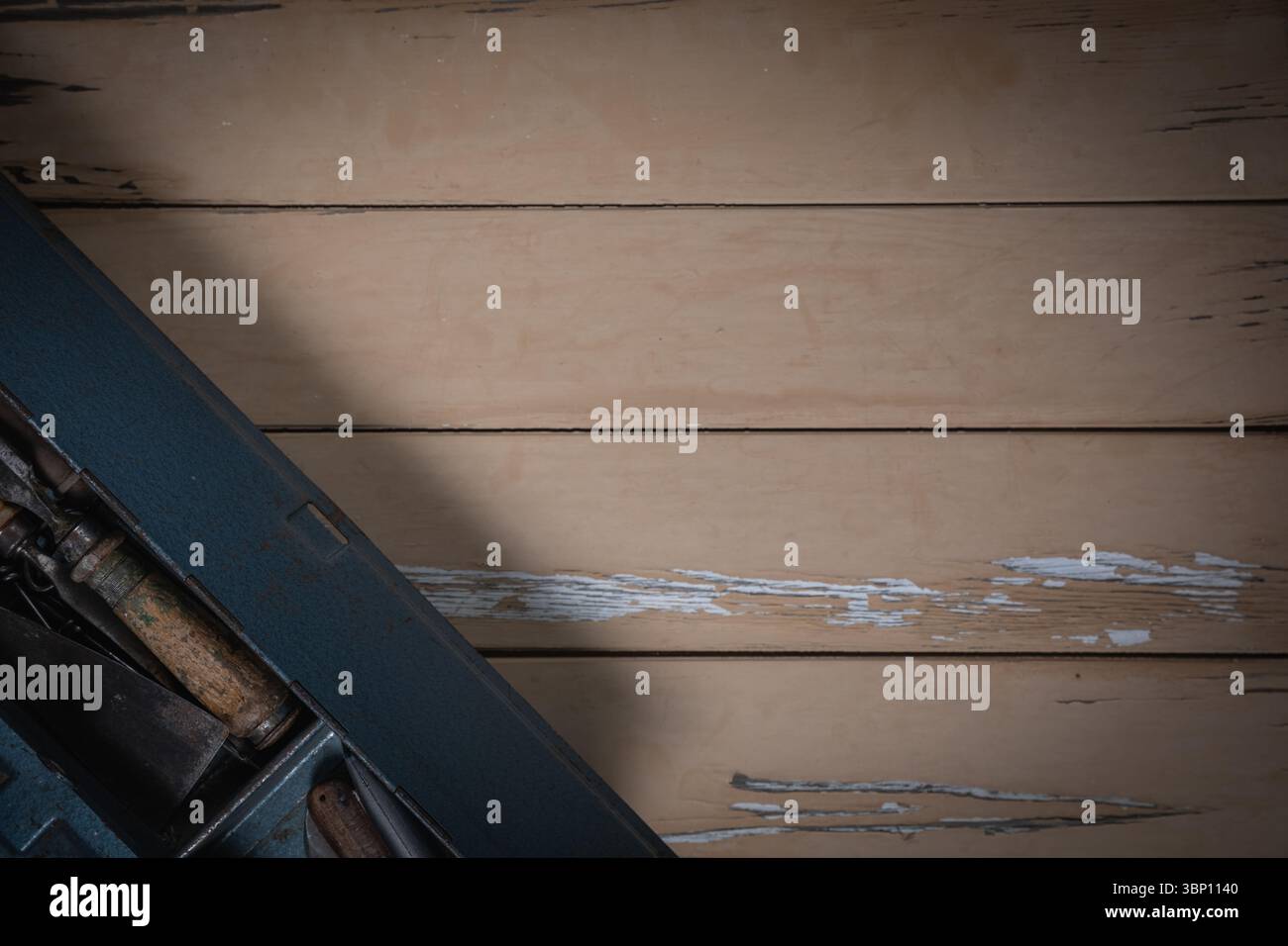 Top-down view of worn beige wooden table with peeling paint, open ...