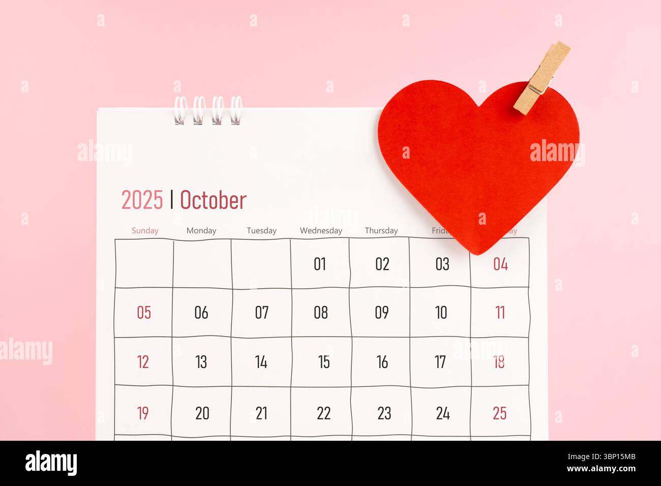 October 2025 desk calendar with red heart note on pink background Stock ...