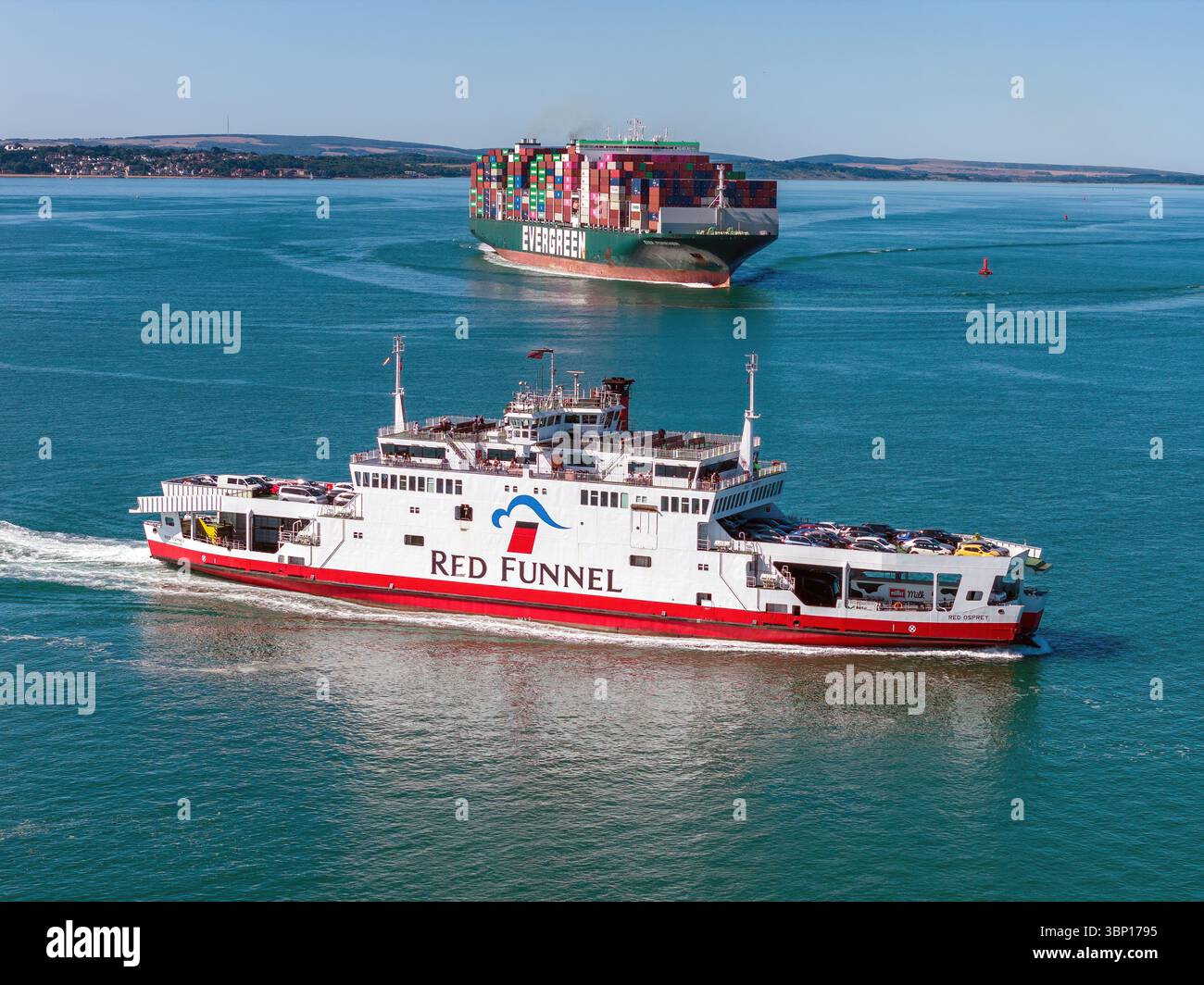 A Red Funnel ferry and Evergreen container ship traffic close together ...