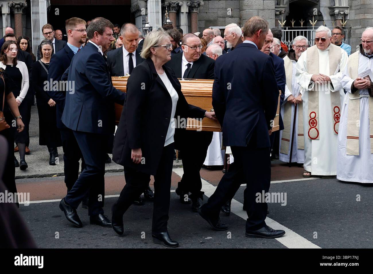 The remains of Brother Kevin Crowley are brought from St. Mary of the ...