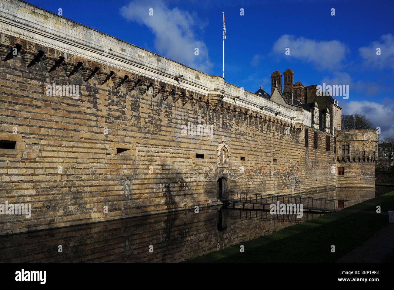 Flamboyant Gothic niche above postern gate and footbridge spanning moat ...