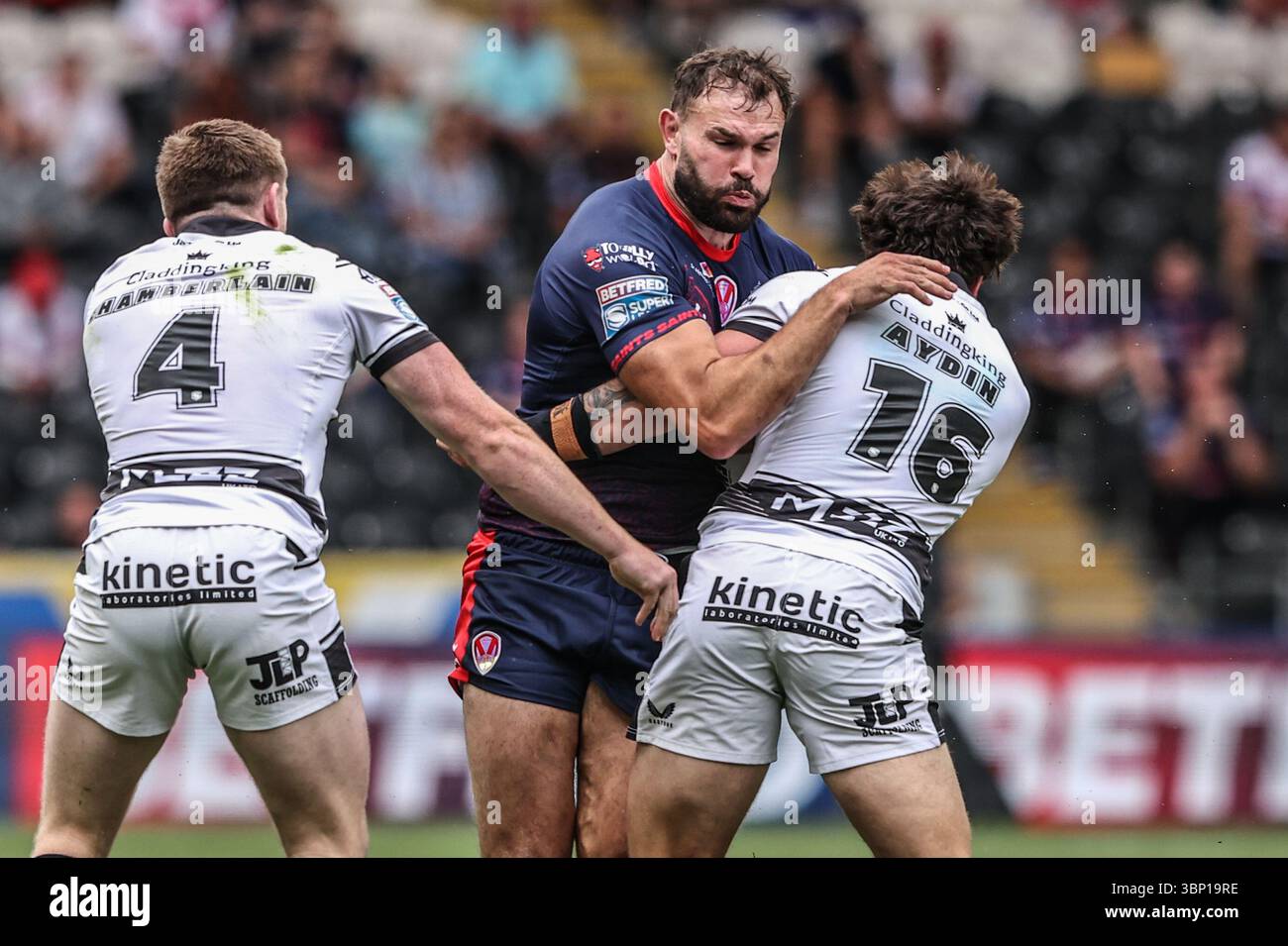 Alex Walmsley of St. Helens is tackled by Ed Chamberlain of Hull FC and ...