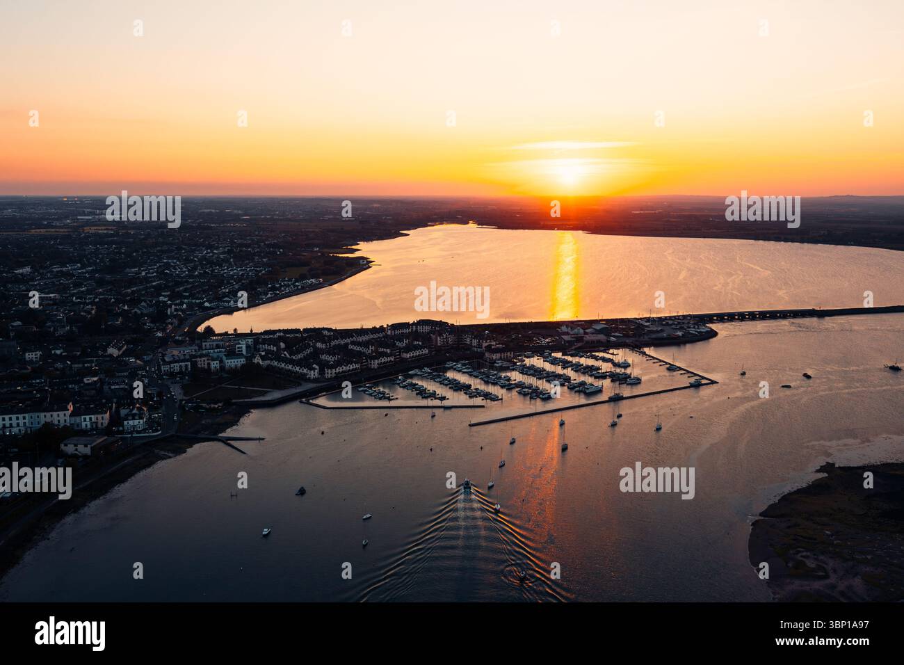 Top down view of a boat returning to dock at Malahide Marina surrounded ...