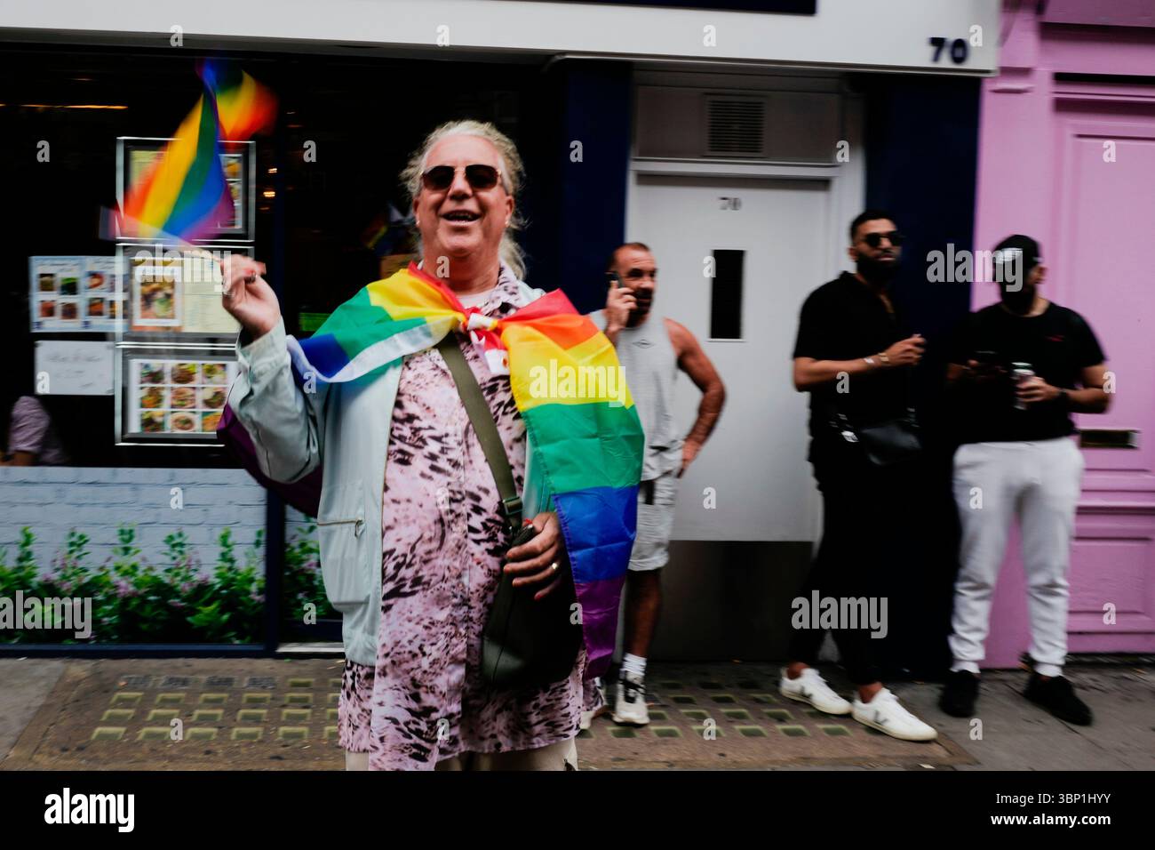 A preson waves a flag in the streets of Soho during the Pride in London ...