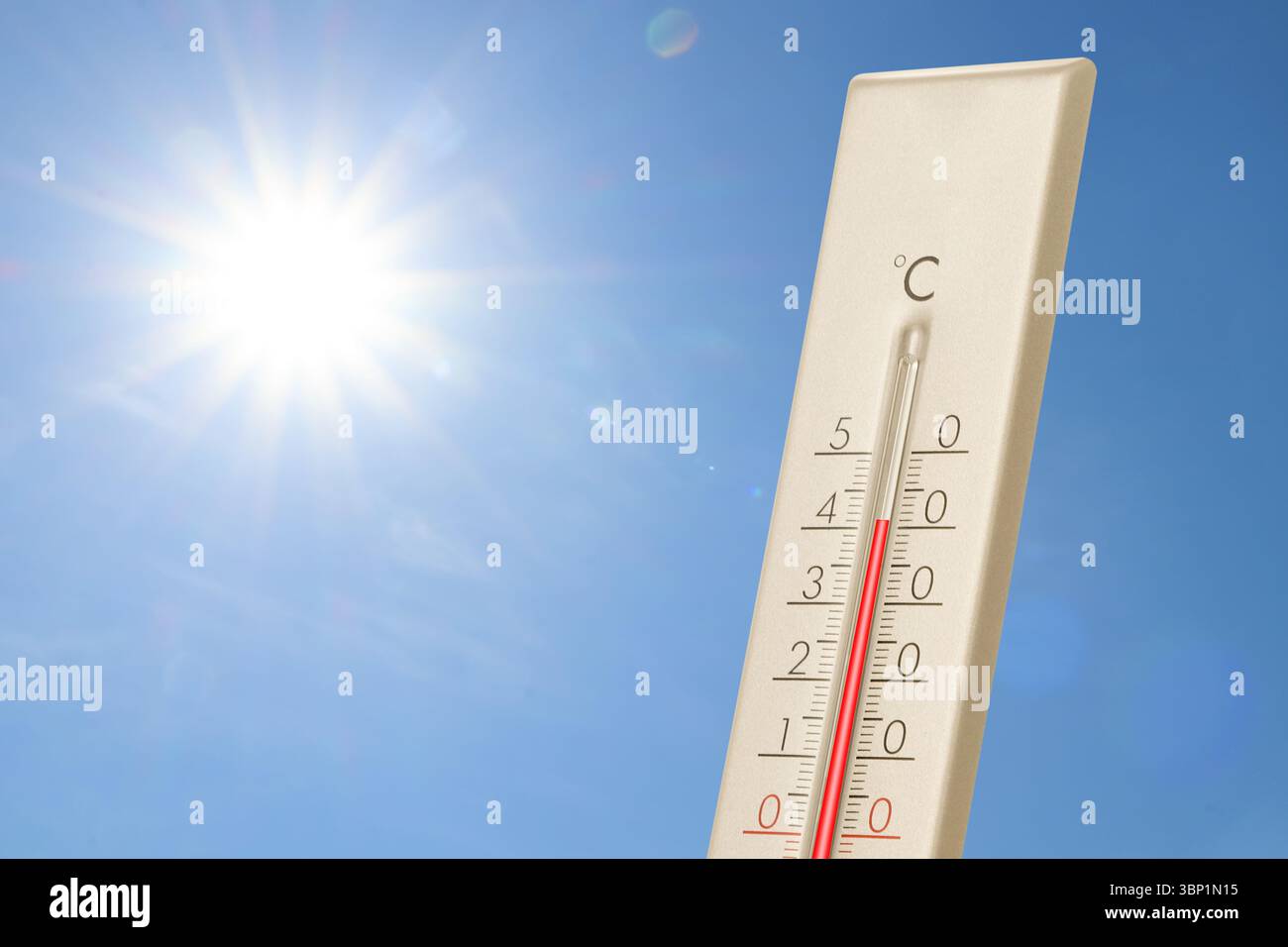 High temperature on thermometer against blue sky on sunny day. Summer ...