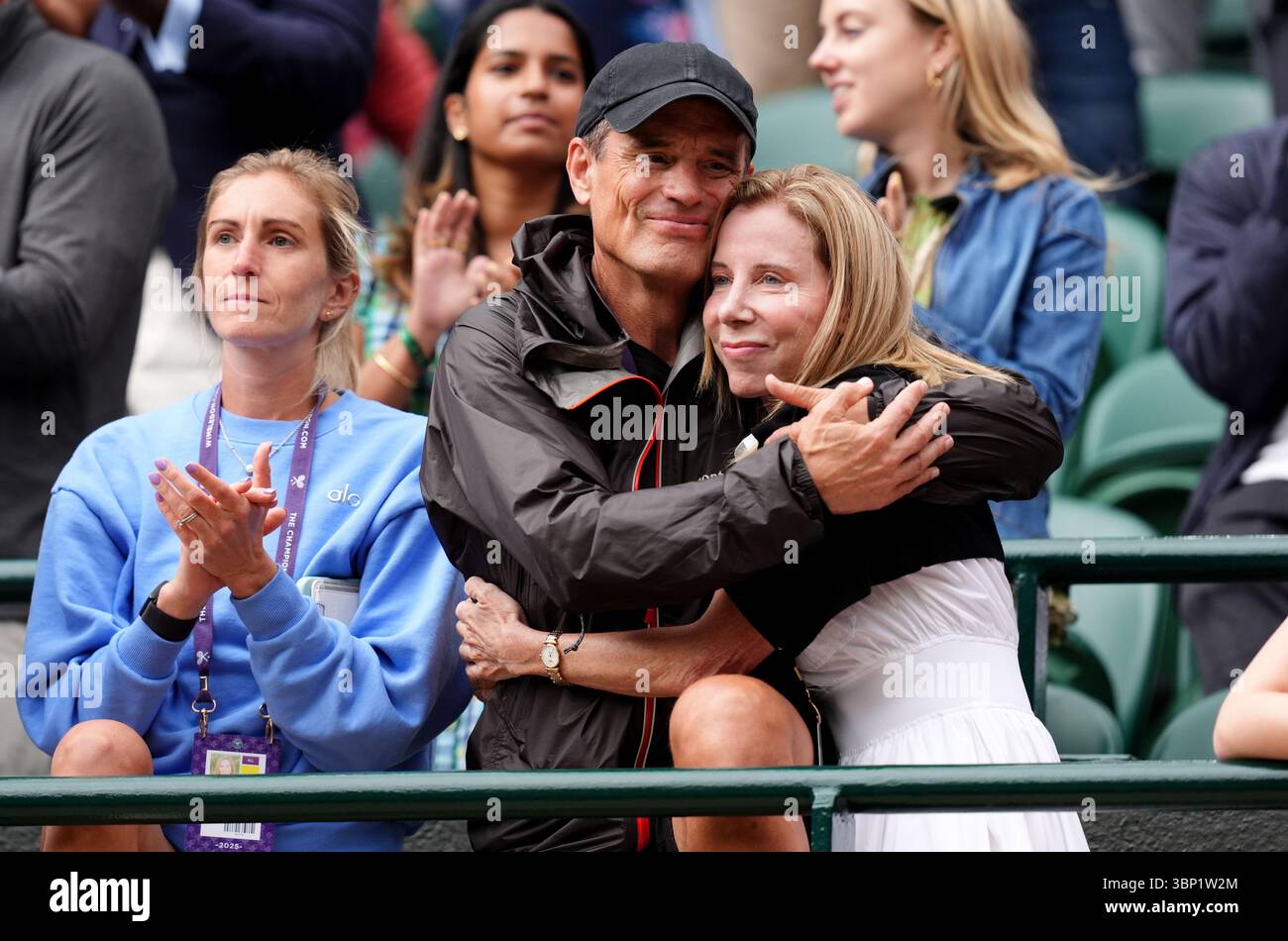 Ben and Kelly Navarro, parents of Emma Navarro, looking on from centre ...