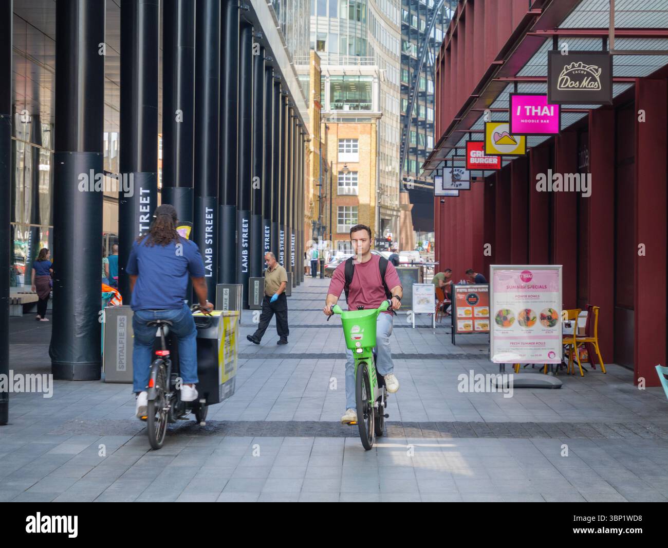 Cyclists pass through Lamb Street, a designated pedestrian precinct in ...