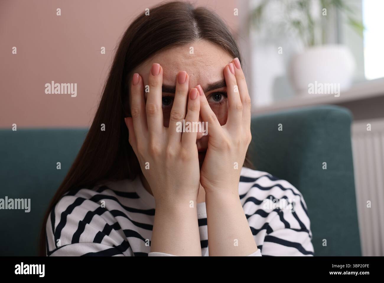 Scared woman suffering from paranoia at home Stock Photo - Alamy