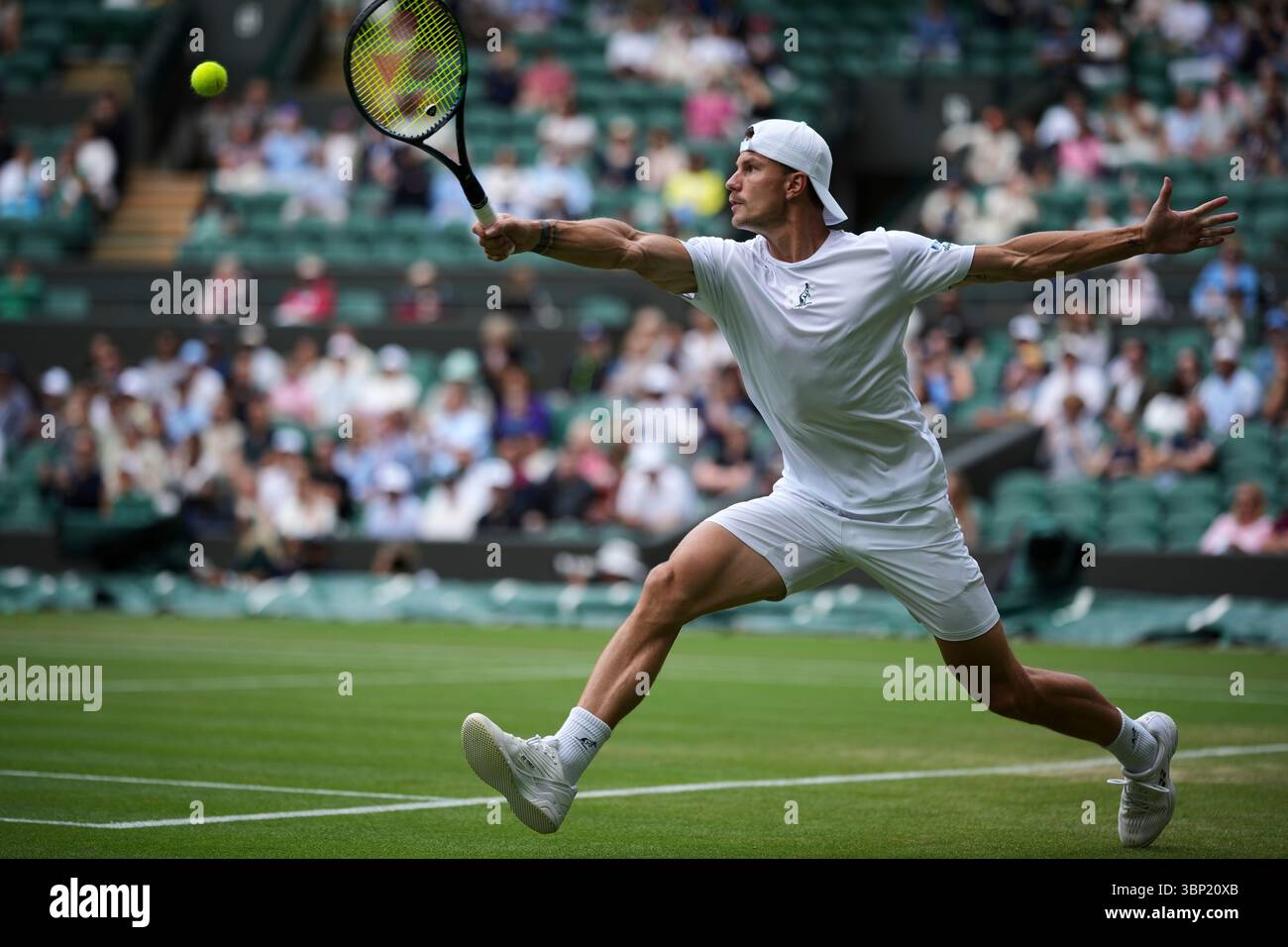 Marton Fucsovics of Hungary returns the ball to Ben Shelton of the U.S ...