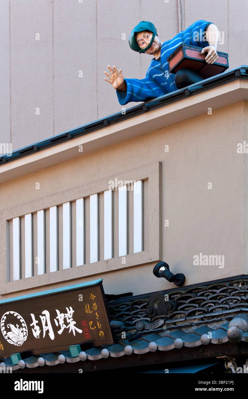 Thief wearing traditional attire escaping across building roof is ...