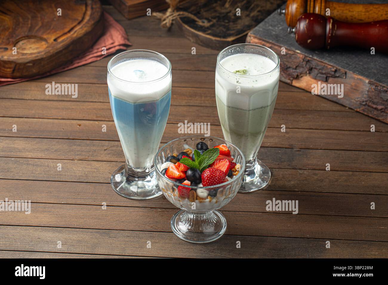 Colorful matcha lattes with dessert and berries Stock Photo - Alamy