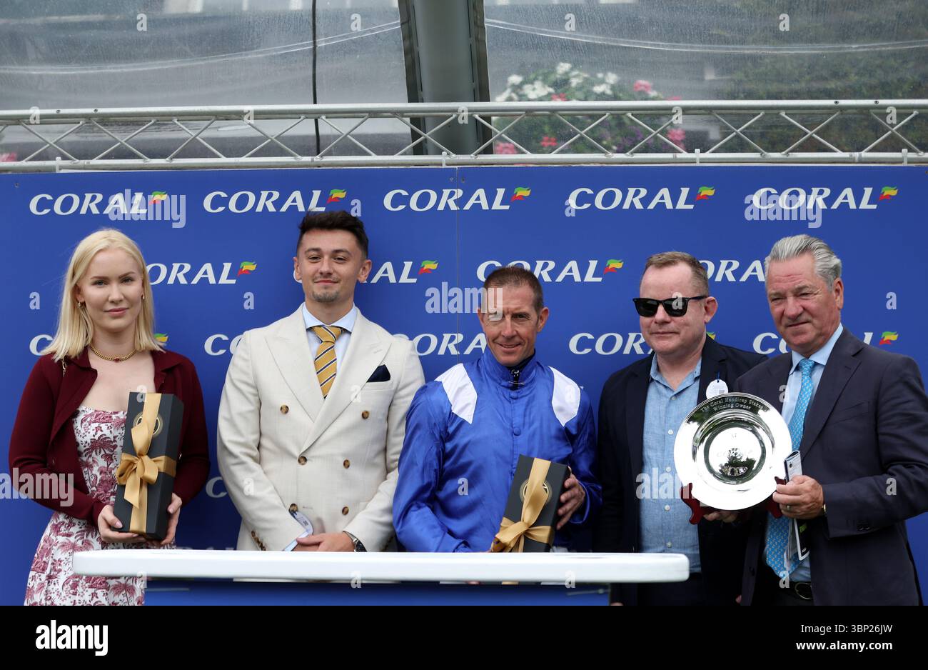 Jockey Jim Crowley (centre) during a trophy presentation after victory ...