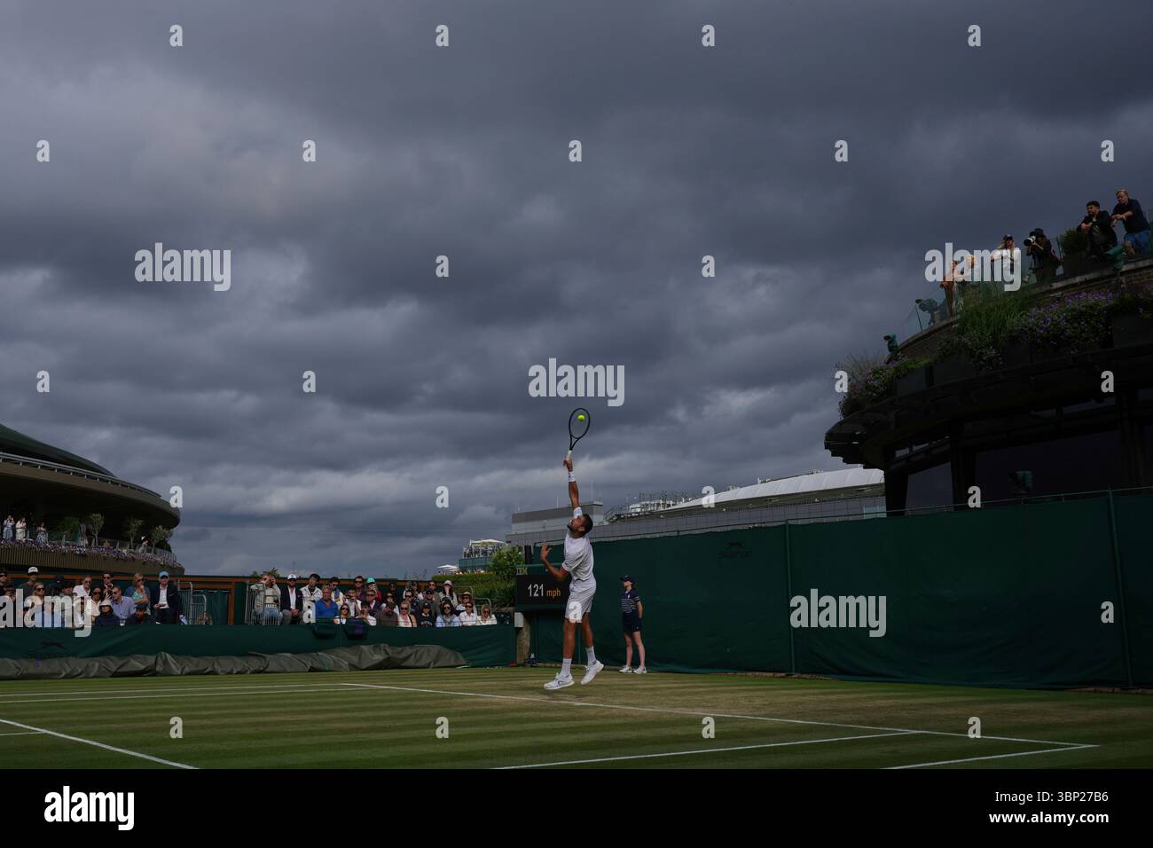Marin Cilic of Croatia serves to Jaume Munar of Spain during a third ...