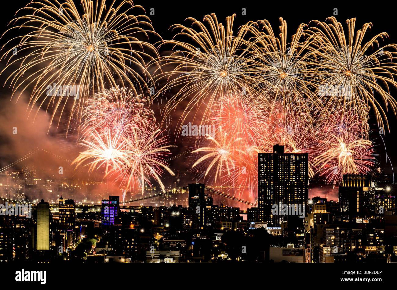 Fireworks explode over the East River and Brooklyn Bridge during the ...