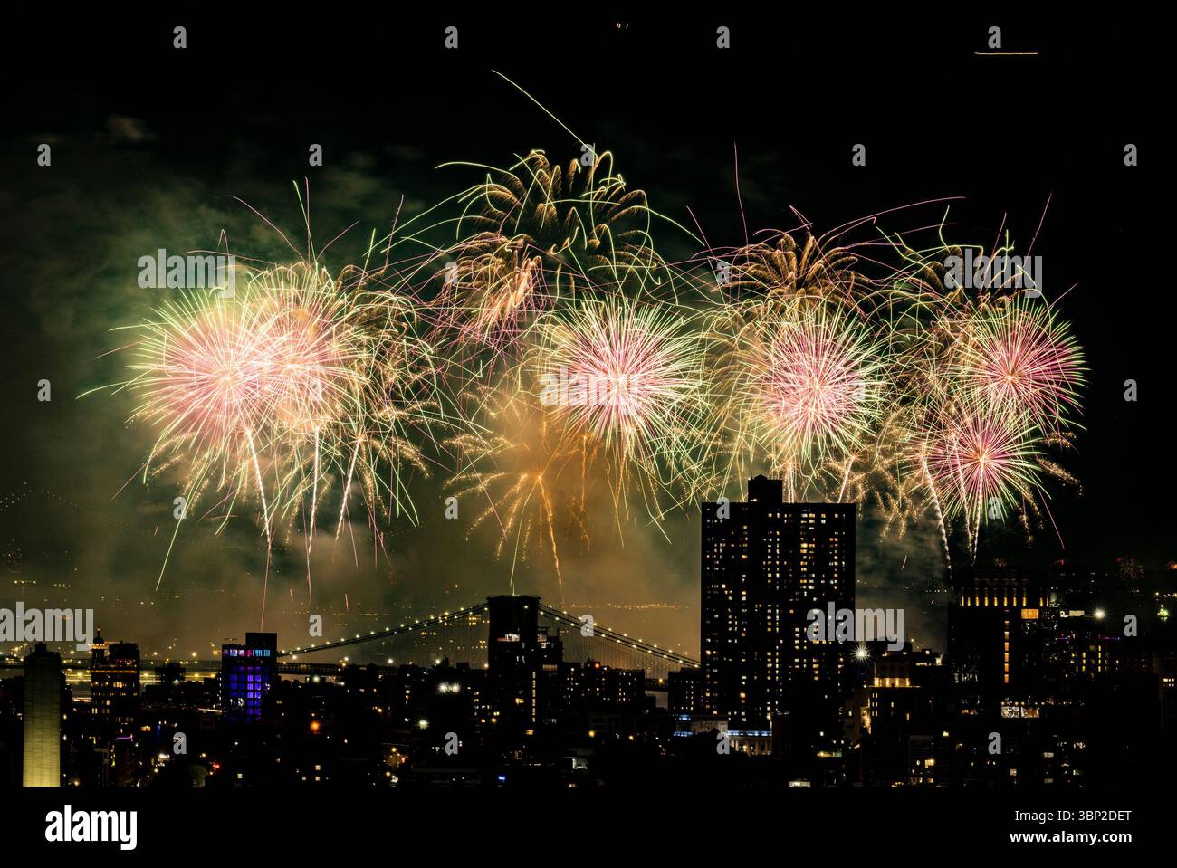 Fireworks explode over the East River and Brooklyn Bridge during the ...