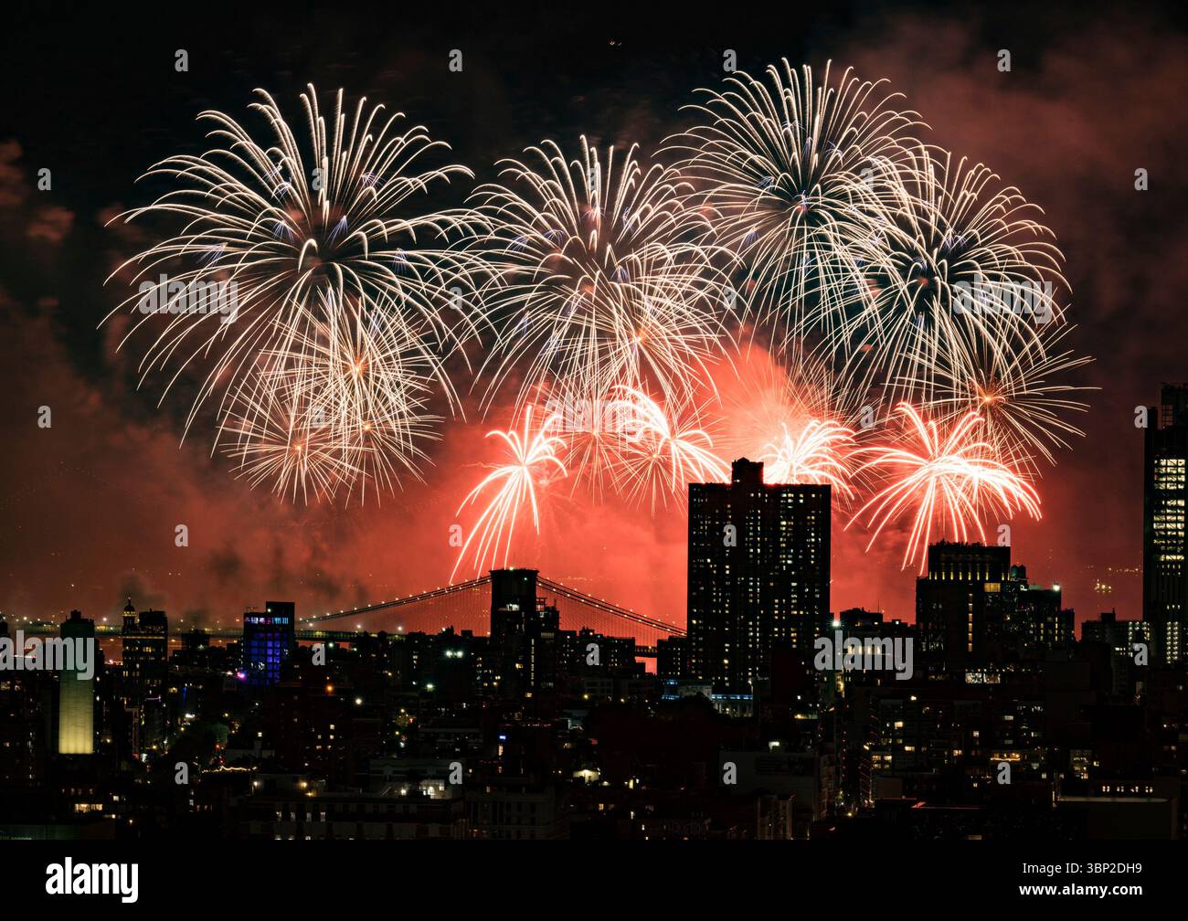 Fireworks explode over the East River and Brooklyn Bridge during the ...
