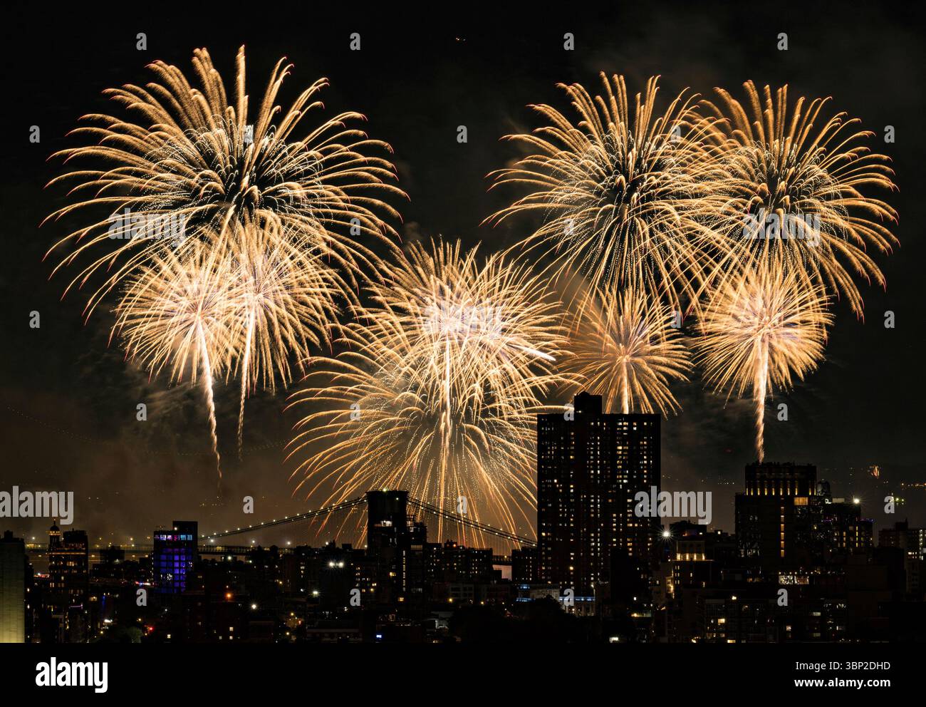 Fireworks explode over the East River and Brooklyn Bridge during the ...