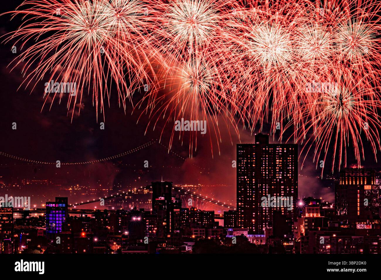 Fireworks explode over the East River and Brooklyn Bridge during the ...