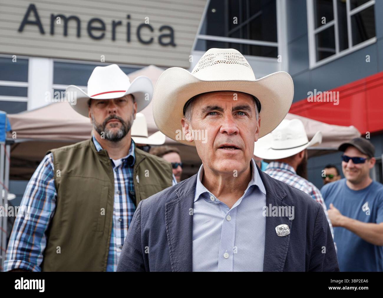 Canada's Prime Minister Mark Carney, centre, attends a Stampede ...