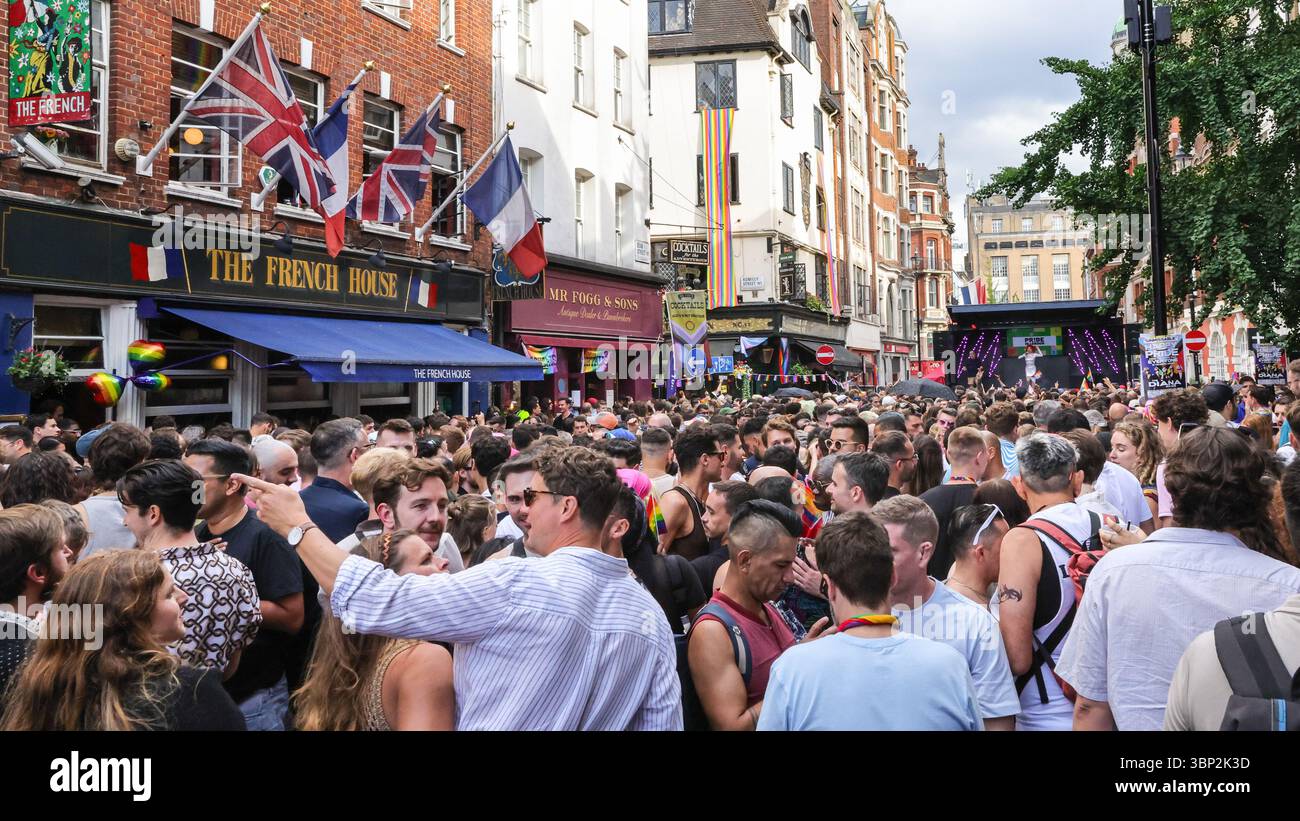 London, UK. 05th July, 2025. Revellers at a performance stage in Dean ...