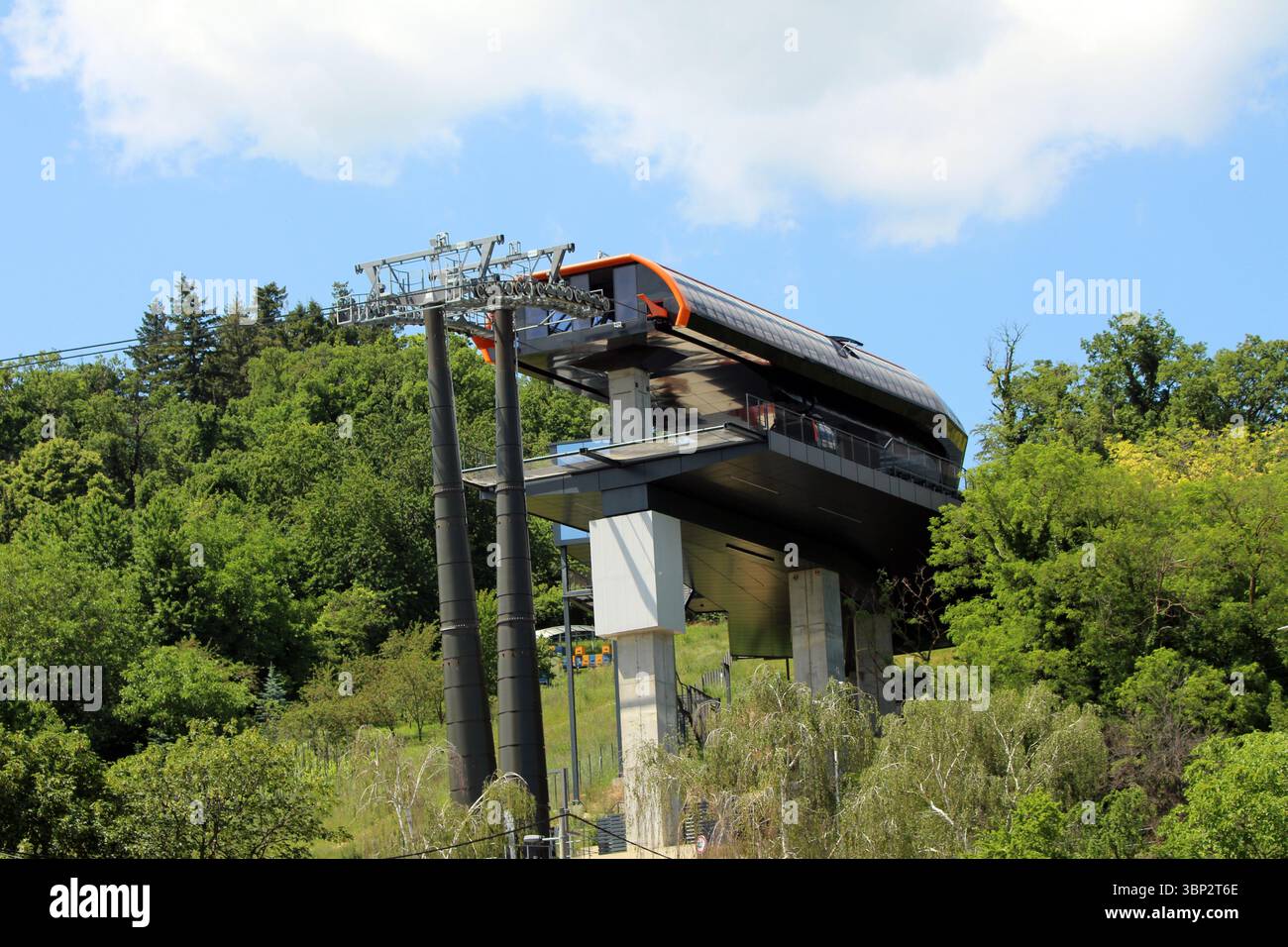 A contemporary cable car station with sleek steel columns and glass ...