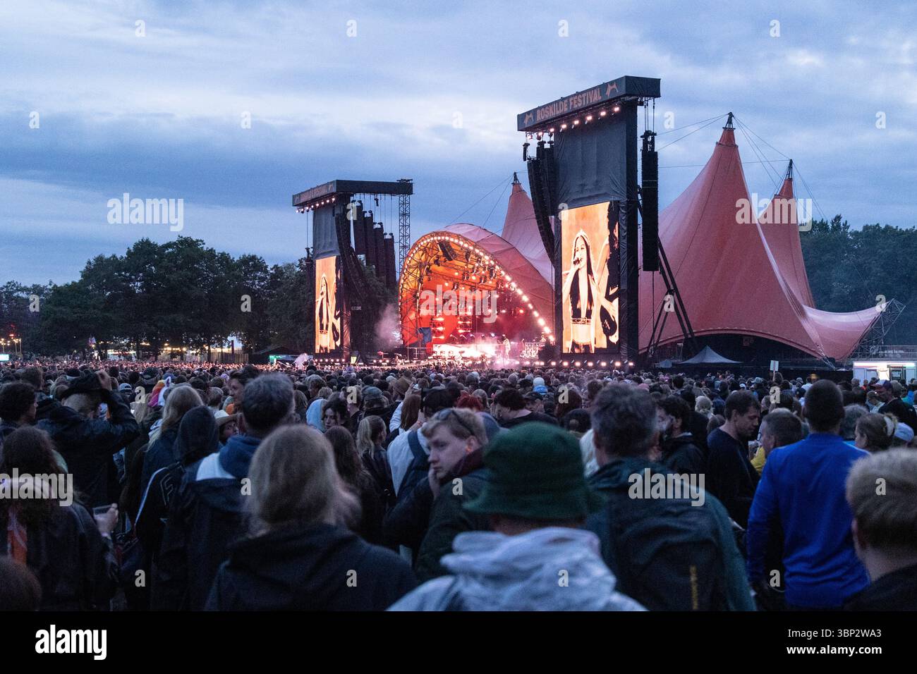 Festival goers seen in front of the Orange Stage at a live concert with ...