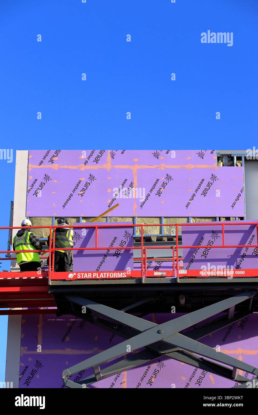 Two workmen on powered access platform hi-res stock photography and ...