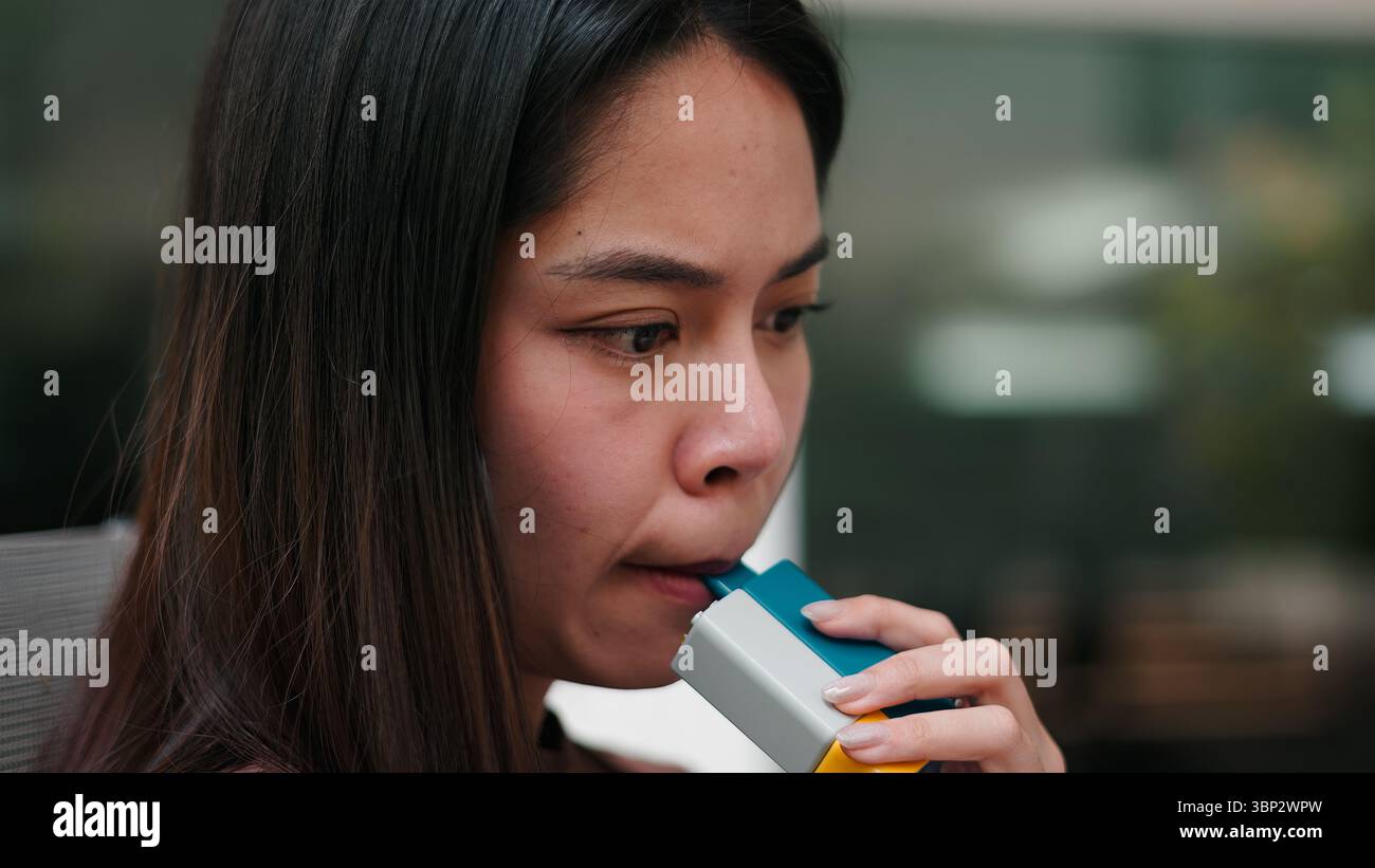 Asian woman using asthma inhaler, relieving respiratory problem ...
