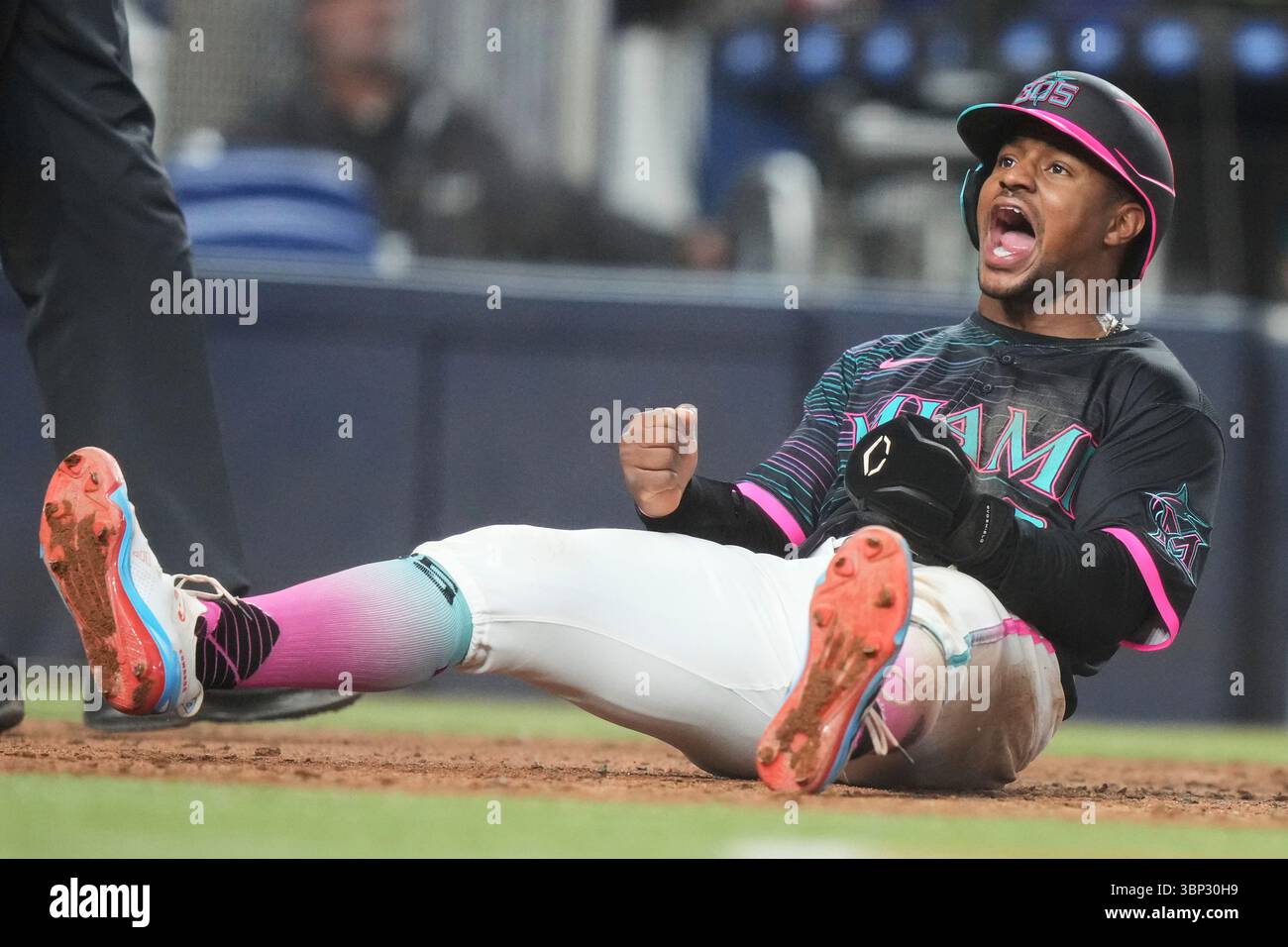 Miami Marlins' Xavier Edwards reacts after scoring on a single hit by ...