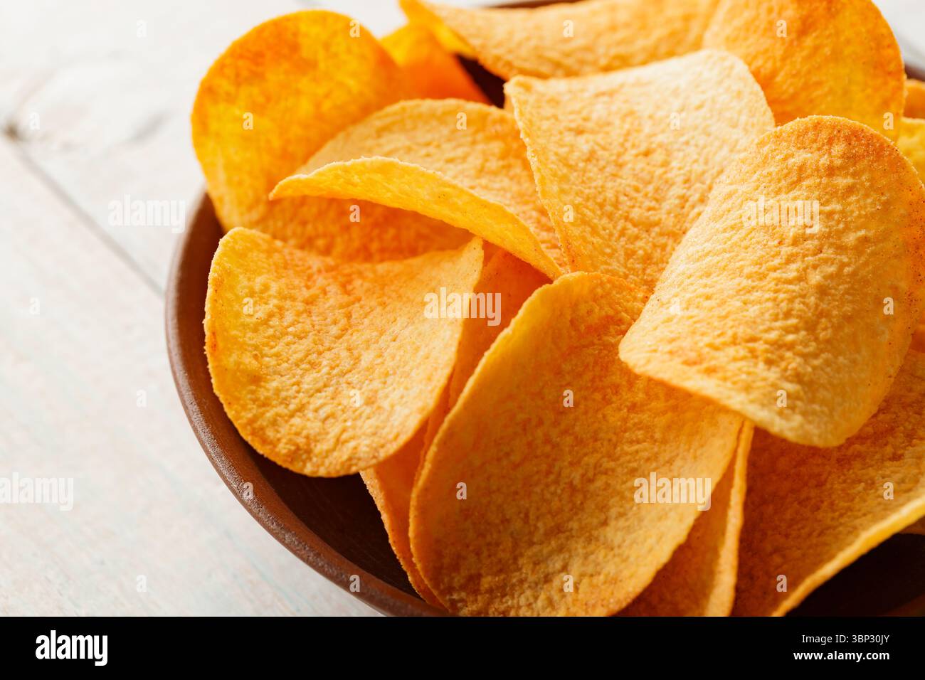 Crispy Potato Chips in Clay Bowl on Rustic Table Stock Photo - Alamy