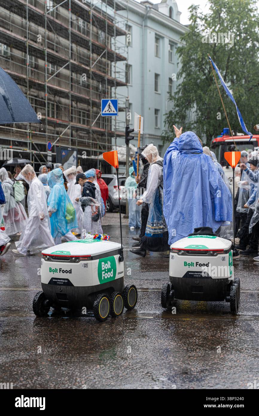 Bolt Food delivery robots at the Song Festival procession in rainy ...